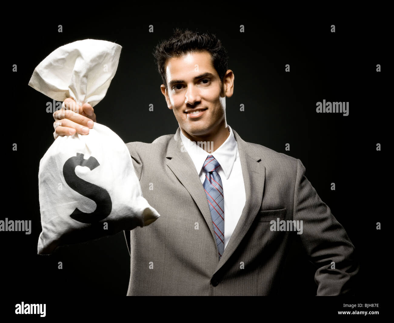 businessman holding a bag of money Stock Photo - Alamy