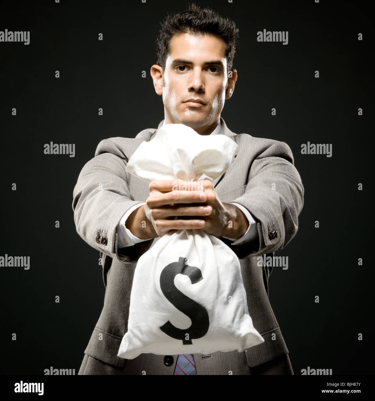 Businessman holding money bag hi-res stock photography and images - Alamy