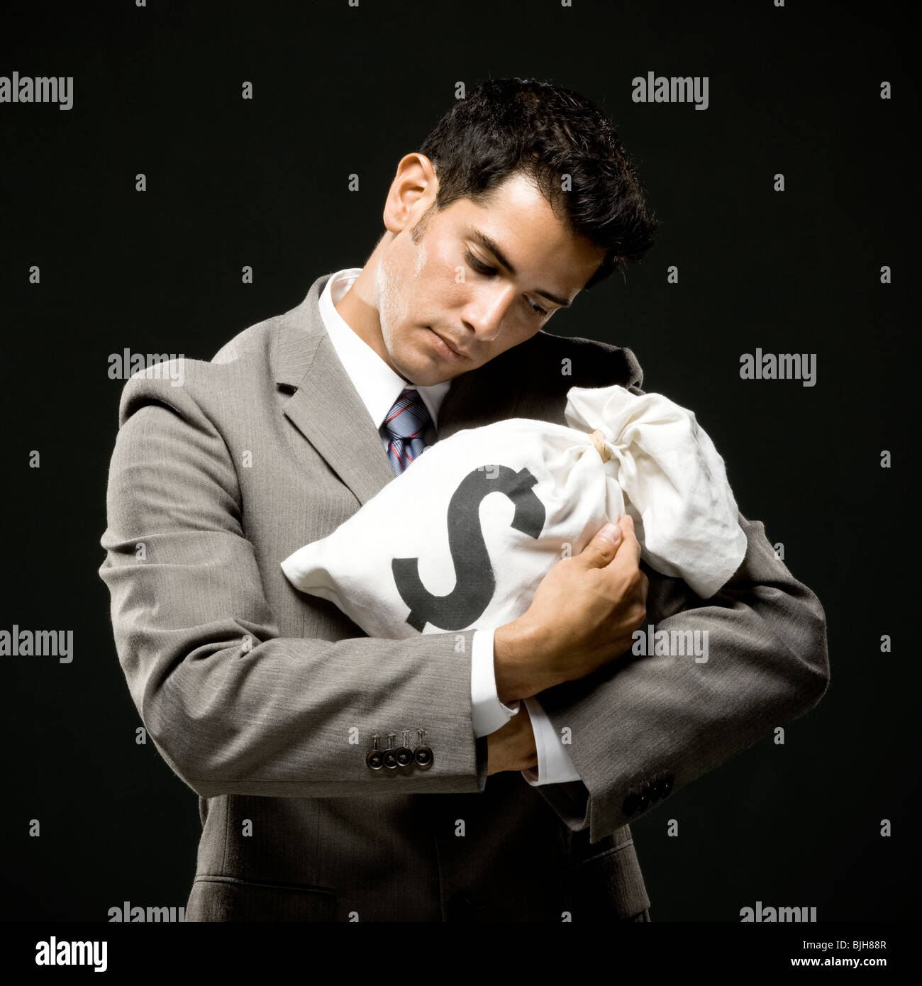 Businessman holding money bag hi-res stock photography and images - Alamy