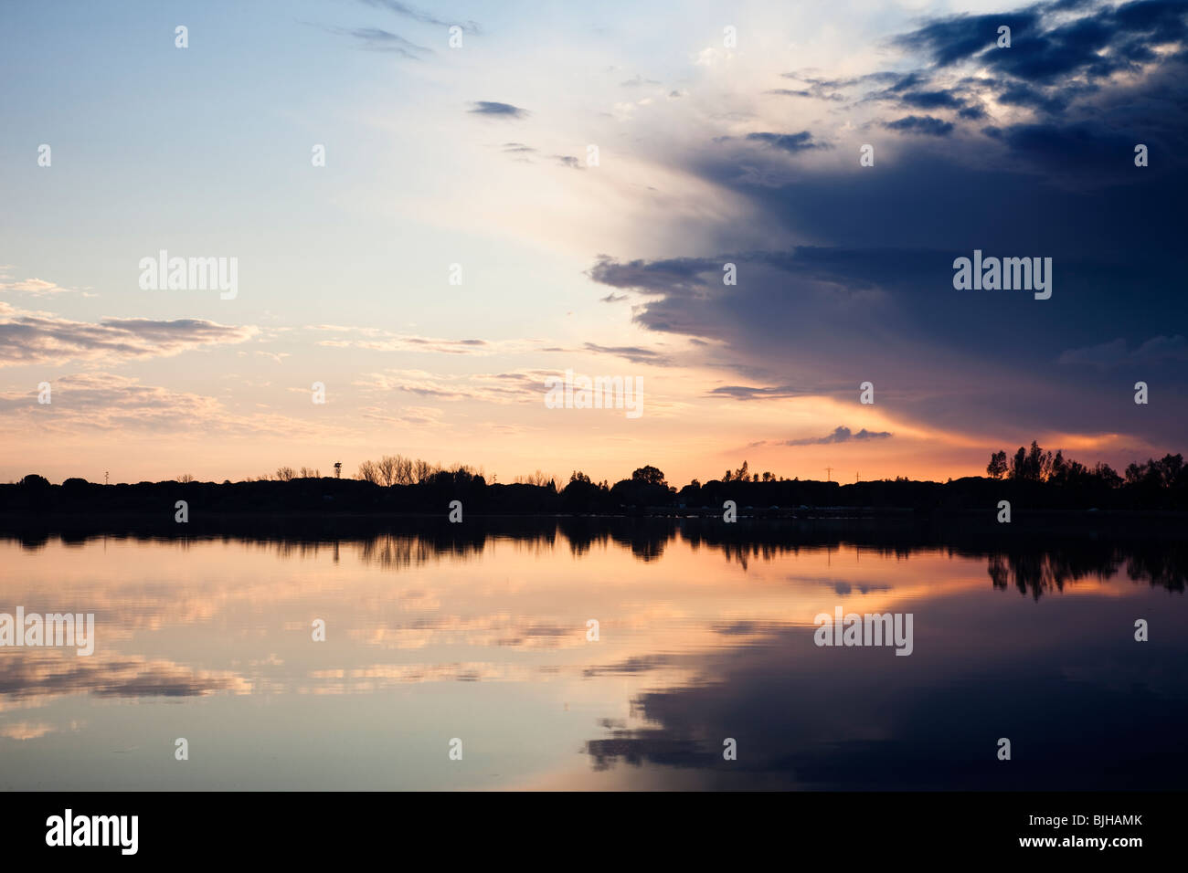 The calm water and the sunset colors are combined in this reflex Stock ...