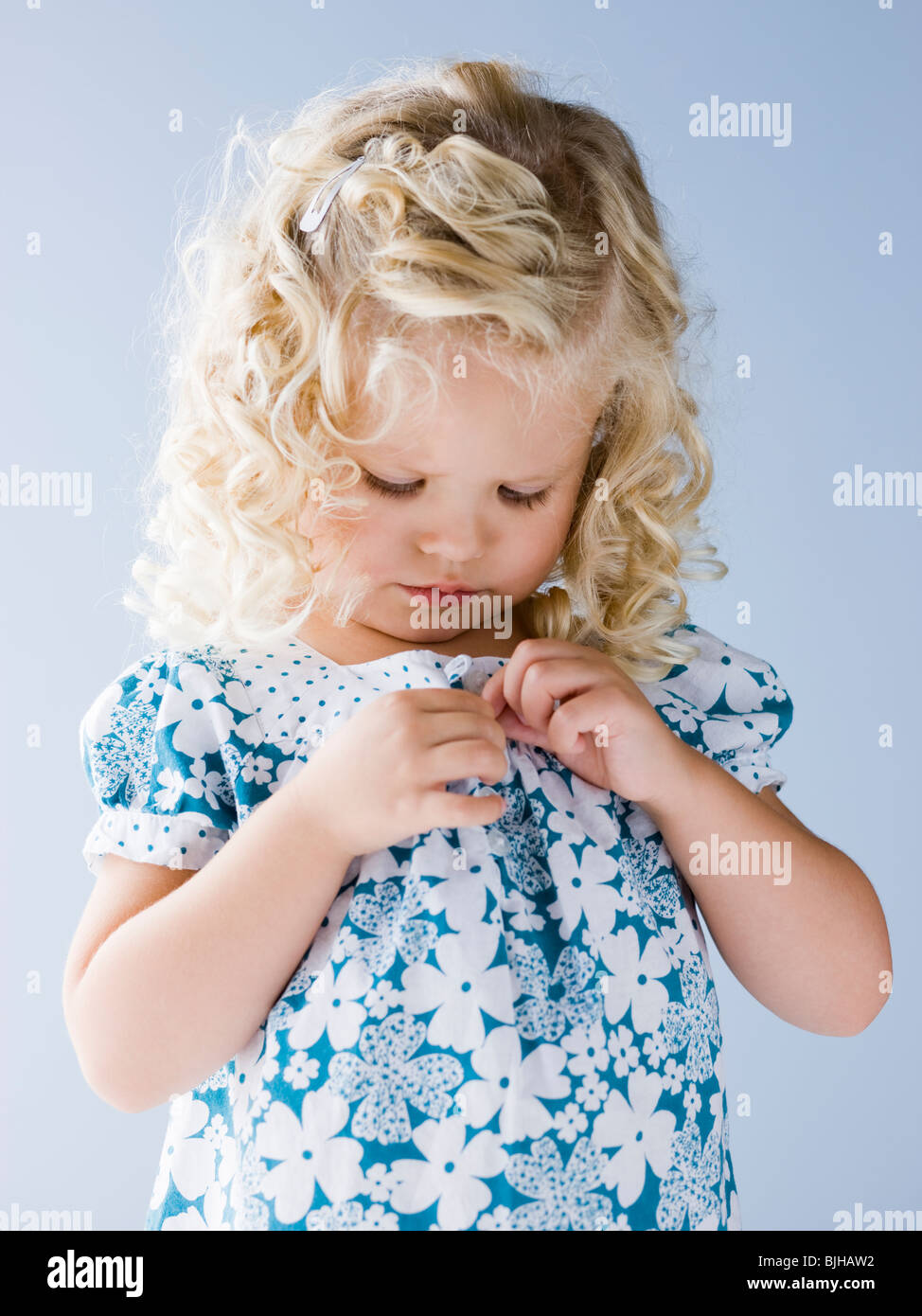 little girl buttoning her shirt Stock Photo - Alamy