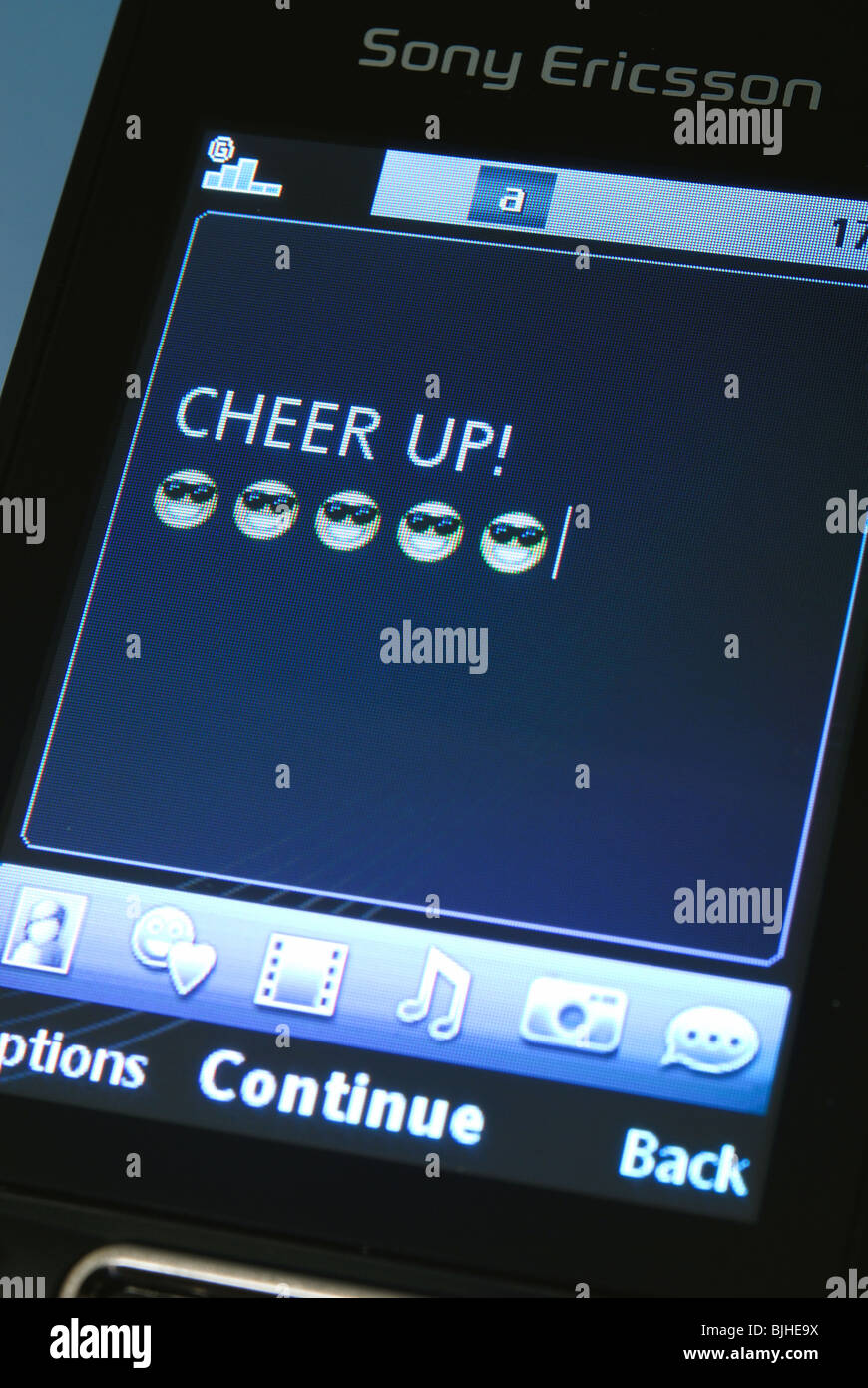 A mobile phone text message telling someone to cheer up Stock Photo - Alamy