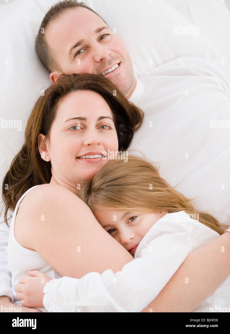 Mum cuddling two daughters hi-res stock photography and images - Alamy