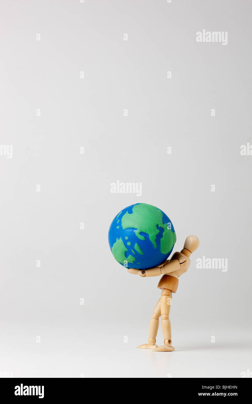 mannequin holding toy earth Stock Photo - Alamy