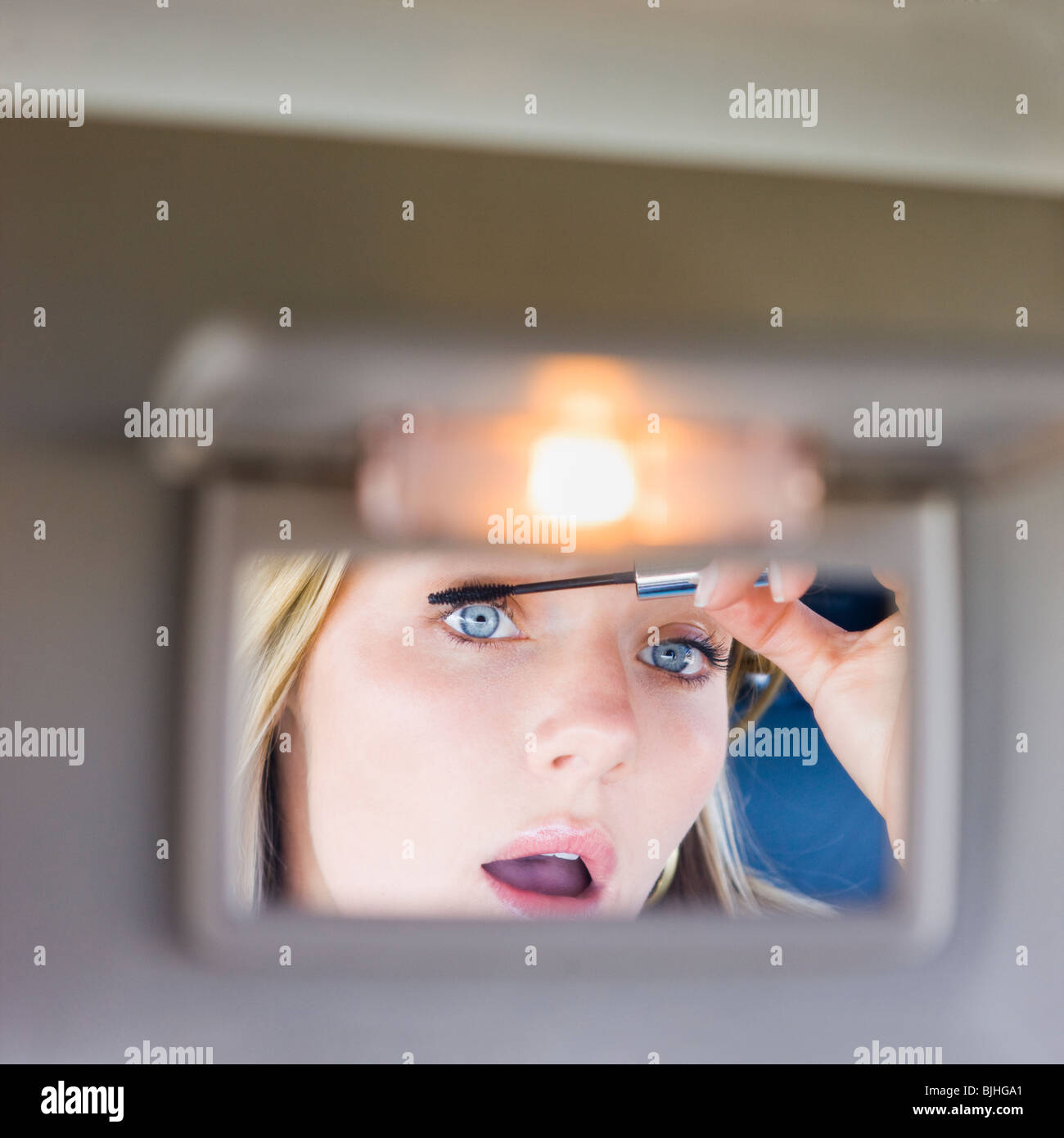 Woman putting on makeup in car hi-res stock photography and images - Alamy