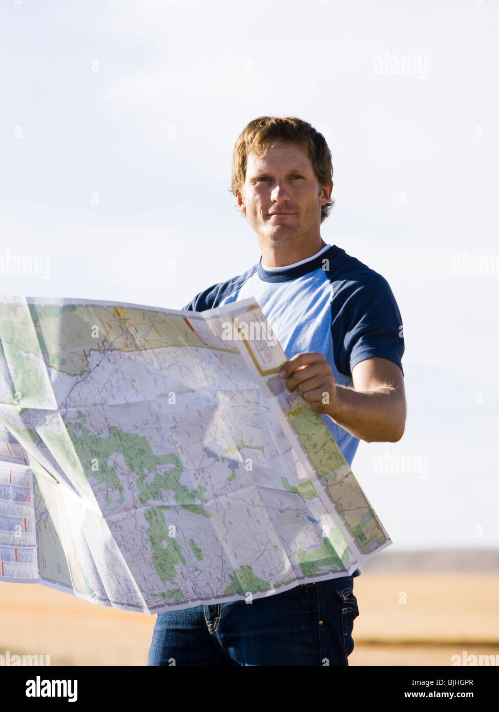 man looking at a map on the side of the road Stock Photo - Alamy