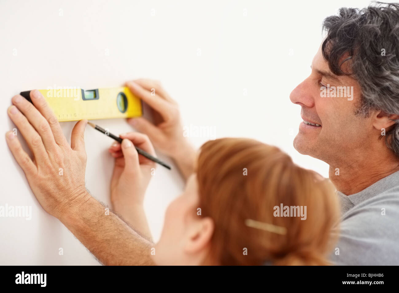 Couple using a level Stock Photo - Alamy