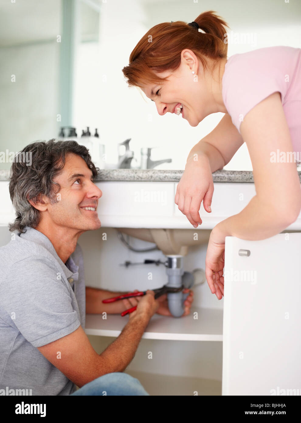 Plumber fixing leaky sink hi-res stock photography and images - Alamy