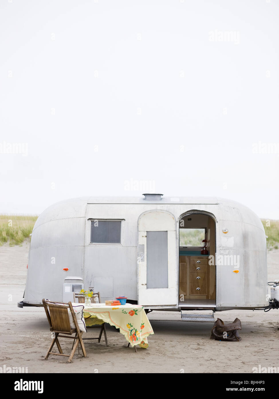 airstream classic trailer with a table set up in front of it on the ...