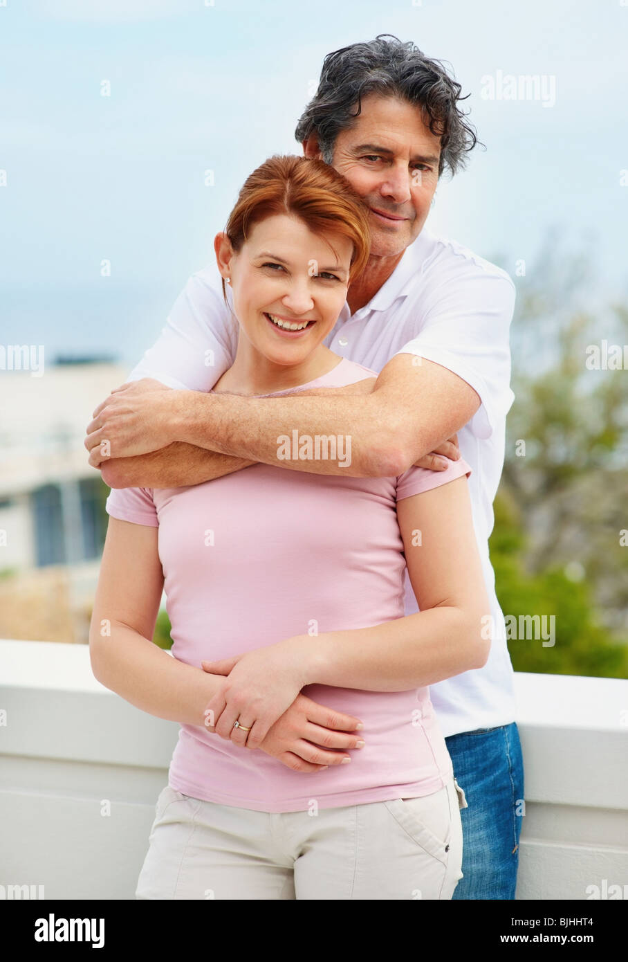 Man embracing woman Stock Photo - Alamy