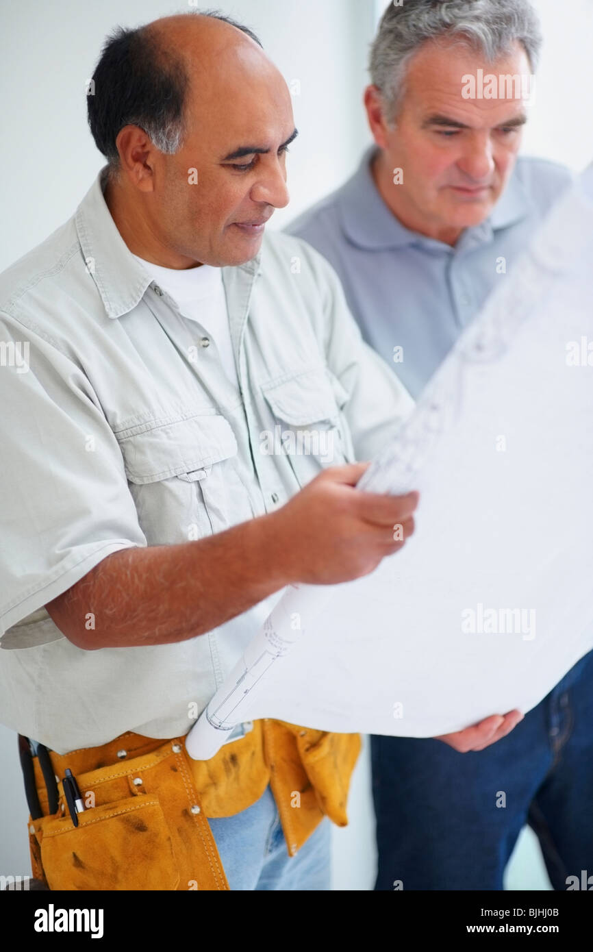 Looking at blueprints Stock Photo - Alamy