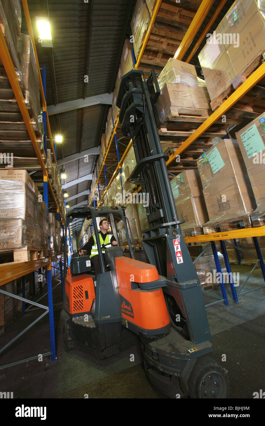 Forklift truck operating in warehouse Stock Photo - Alamy