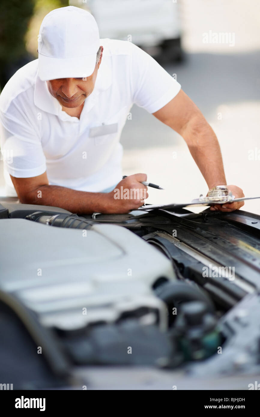 Man looking at car's engine Stock Photo - Alamy