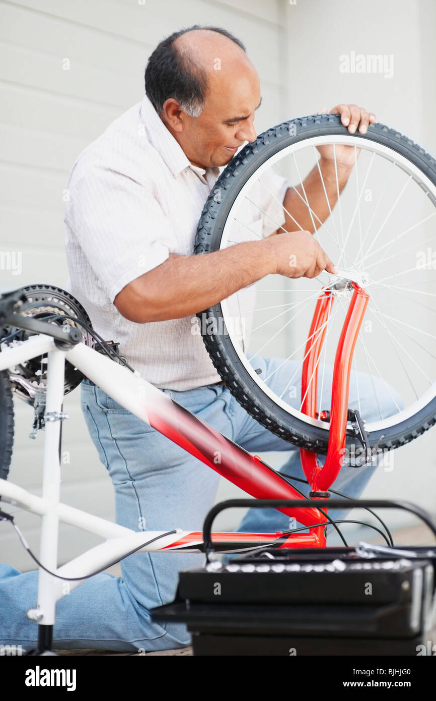 Man repairing bicycle Stock Photo - Alamy