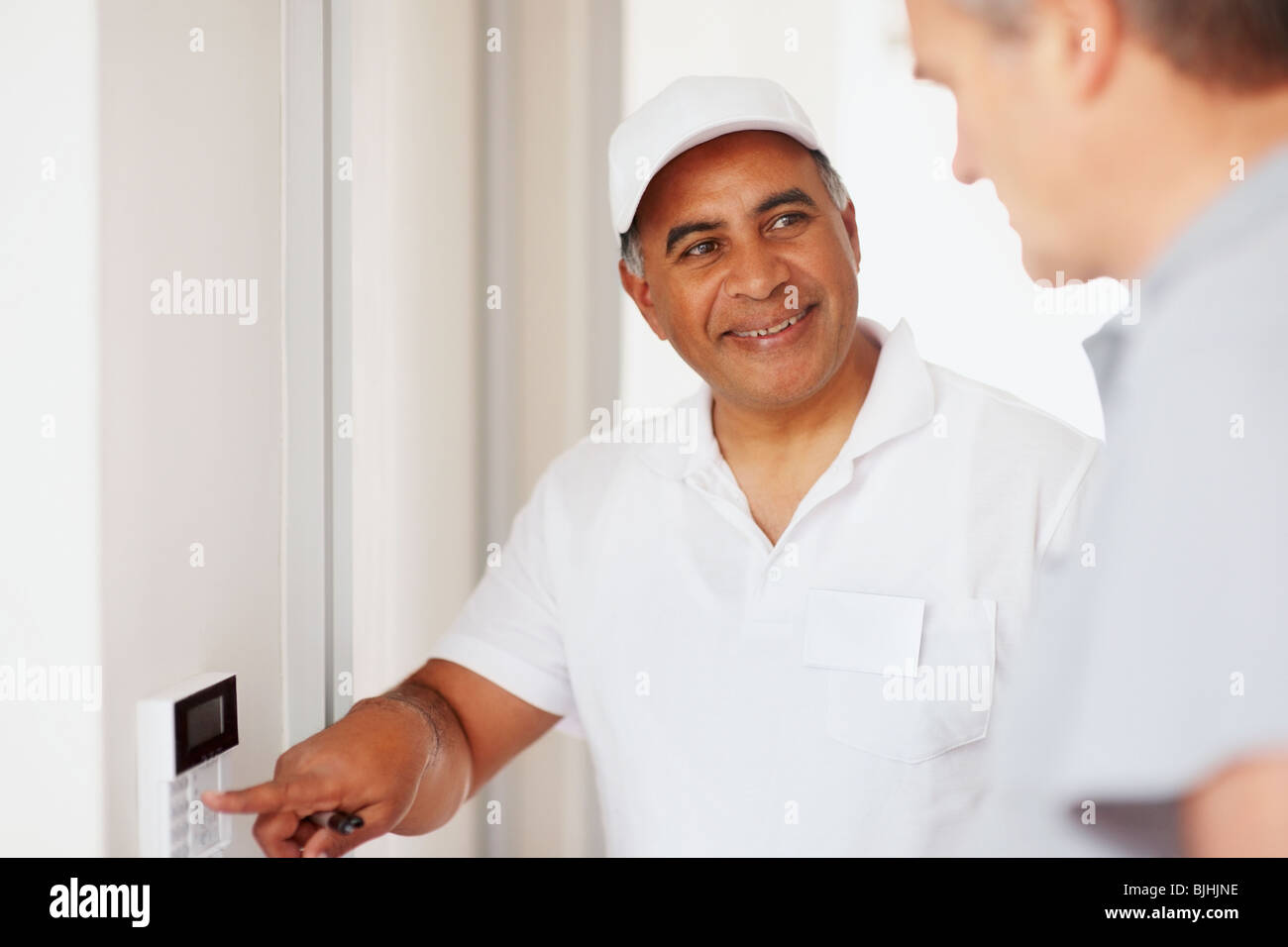 Man demonstrating how alarm system works Stock Photo - Alamy