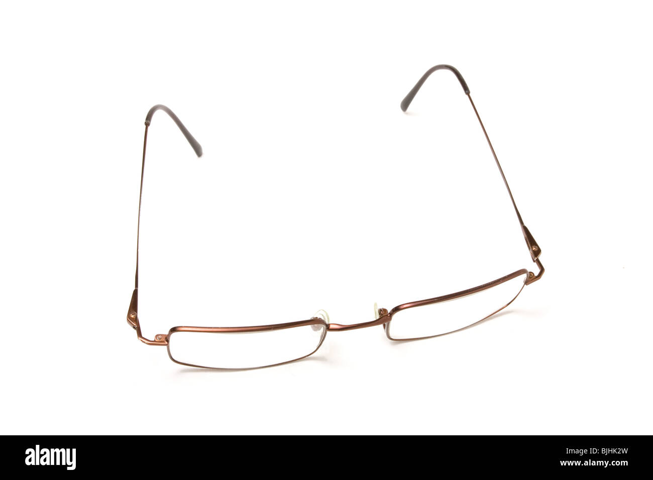 Thin wire framed spectacles close up isolate against white background ...