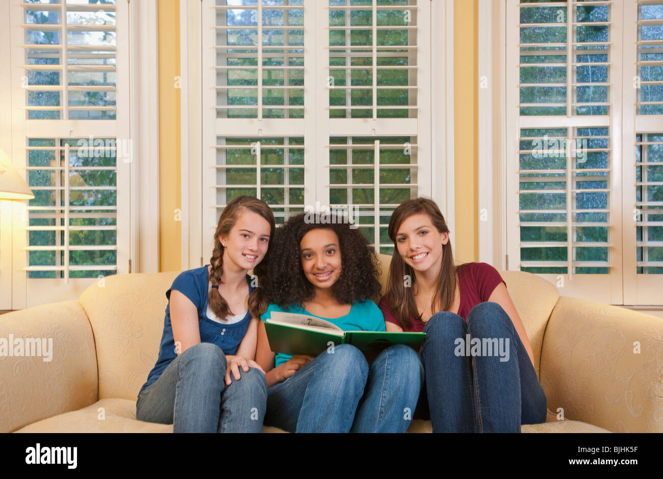 Friends reading book Stock Photo - Alamy
