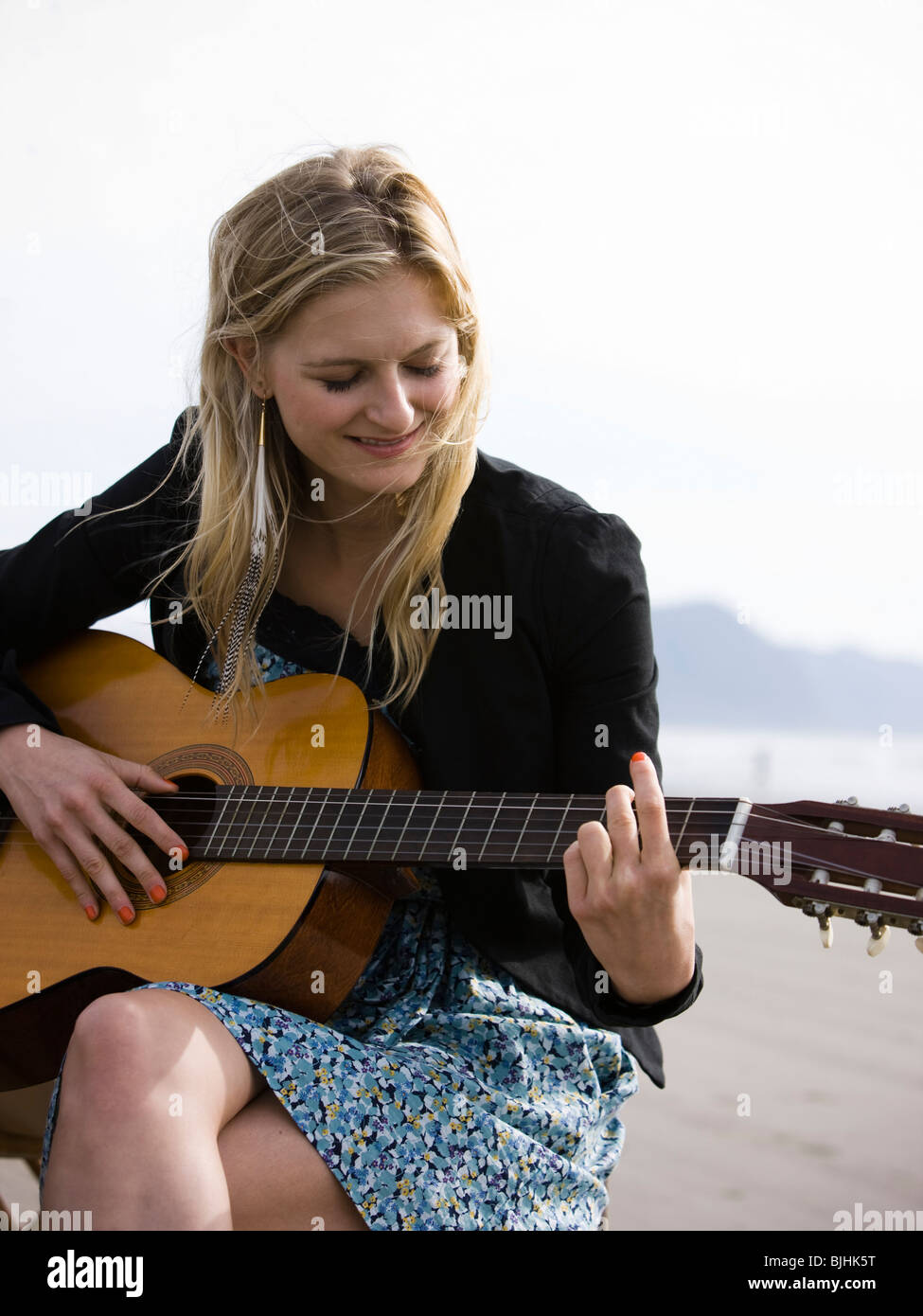 woman playing the guitar at the beach Stock Photo - Alamy