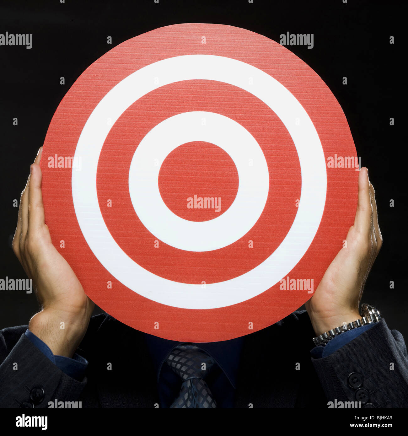 man holding a red target in front of his face Stock Photo - Alamy