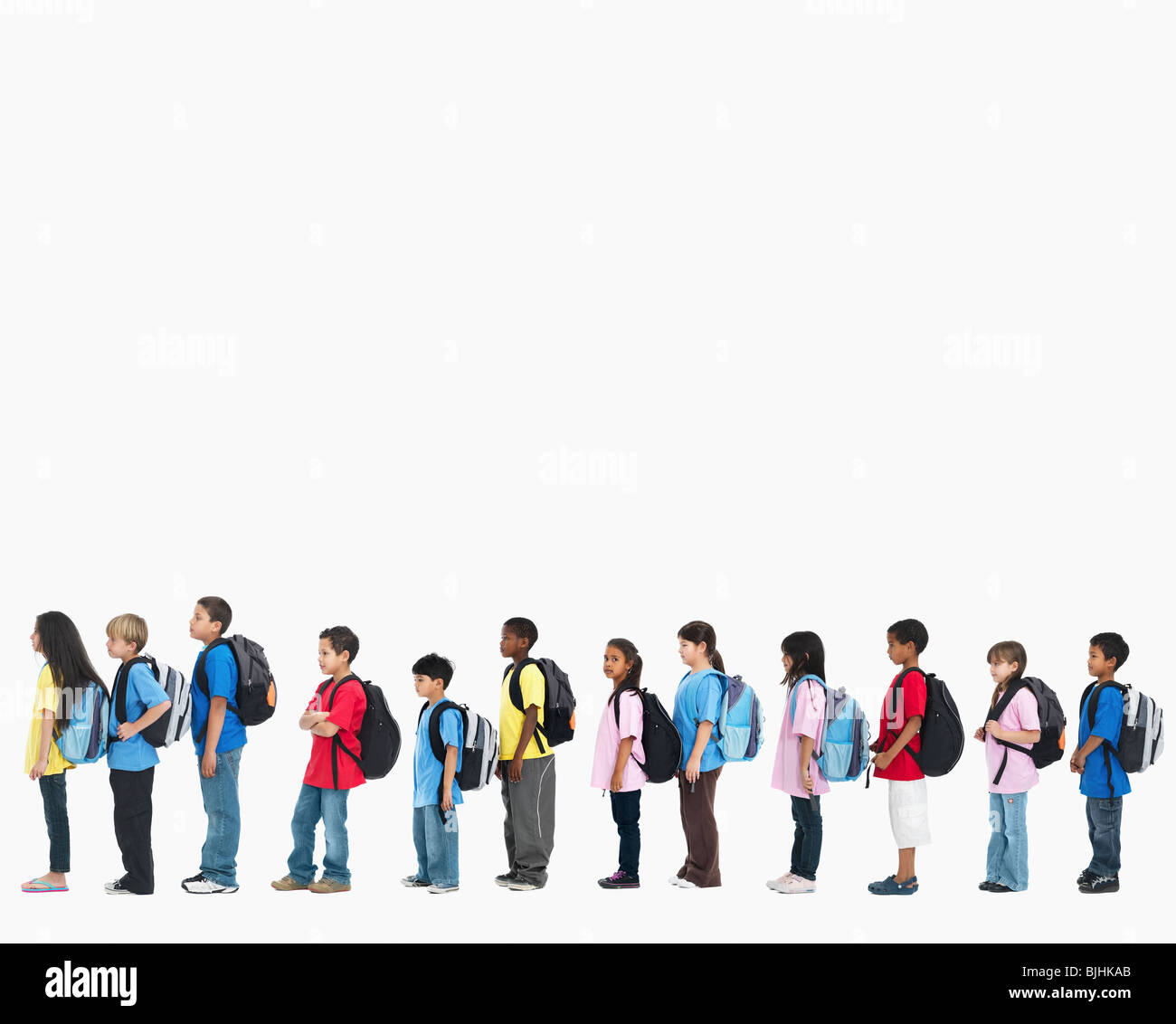Line of children wearing backpacks Stock Photo - Alamy