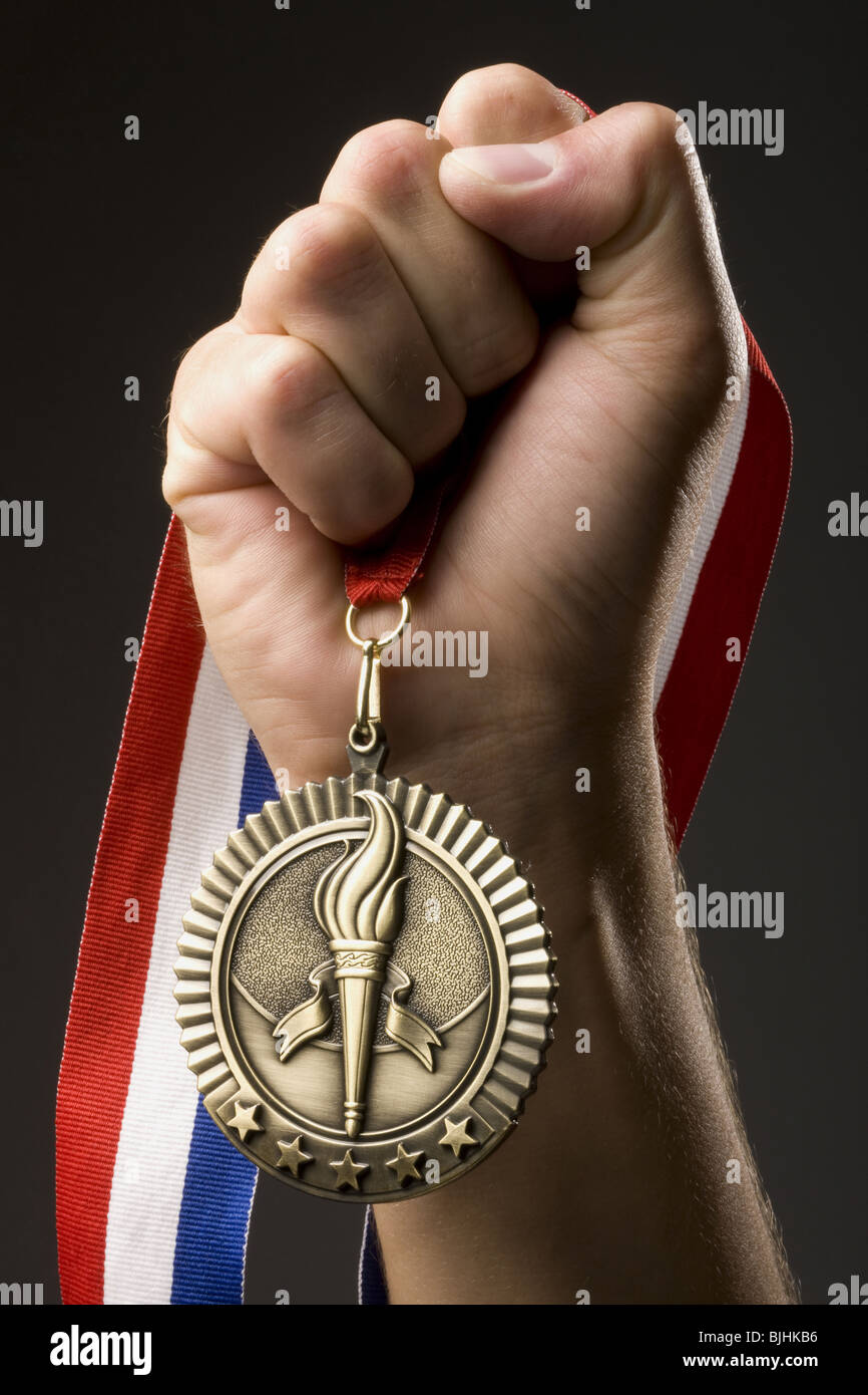 hand holding a gold medal Stock Photo - Alamy