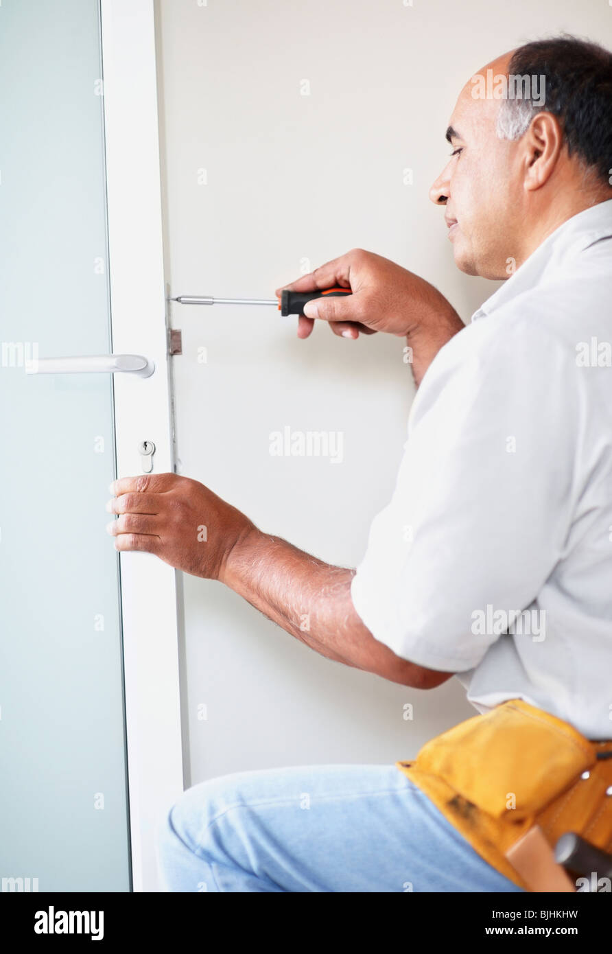 Man fixing door Stock Photo - Alamy