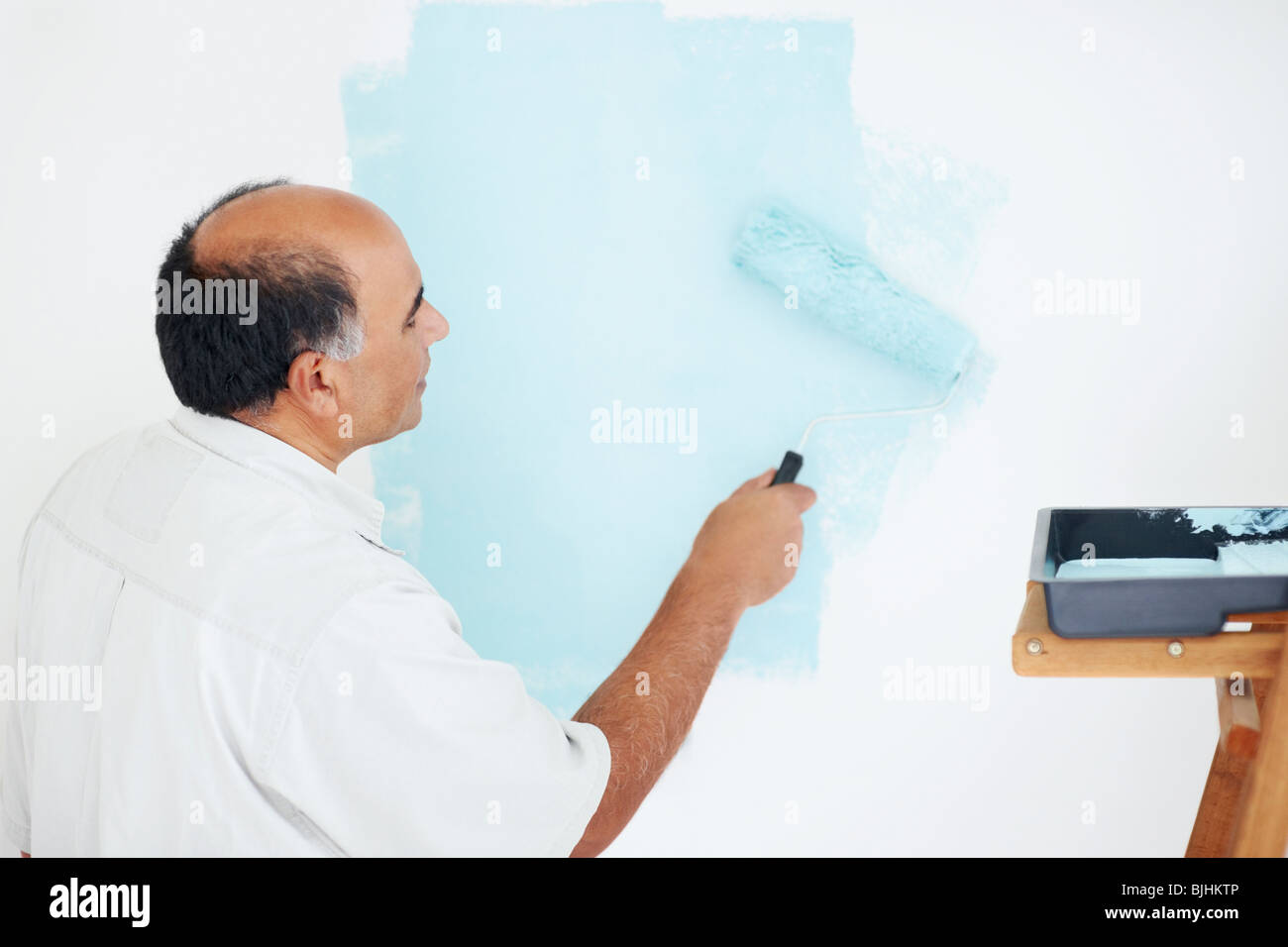 Man painting wall Stock Photo - Alamy