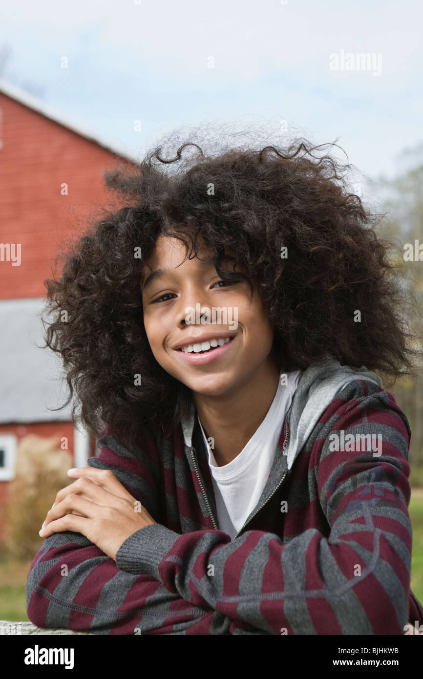 Child leaning on fence Stock Photo - Alamy