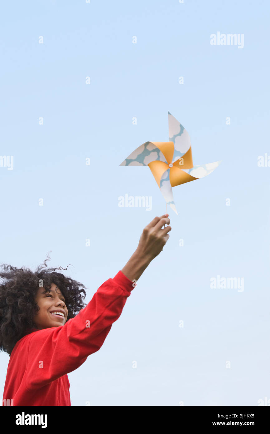 Girl playing with toy windmill Stock Photo - Alamy