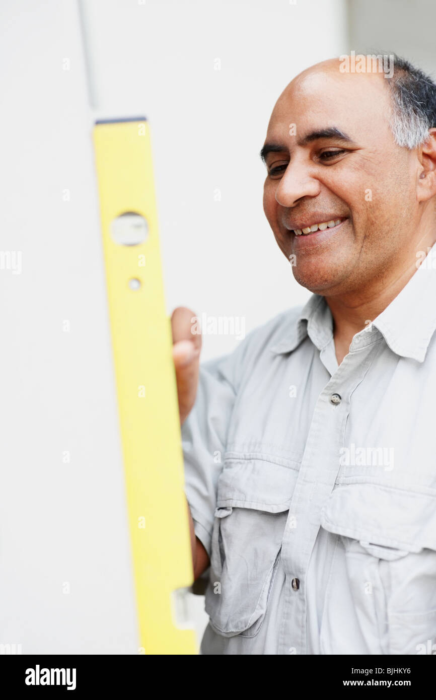 Man using level Stock Photo - Alamy