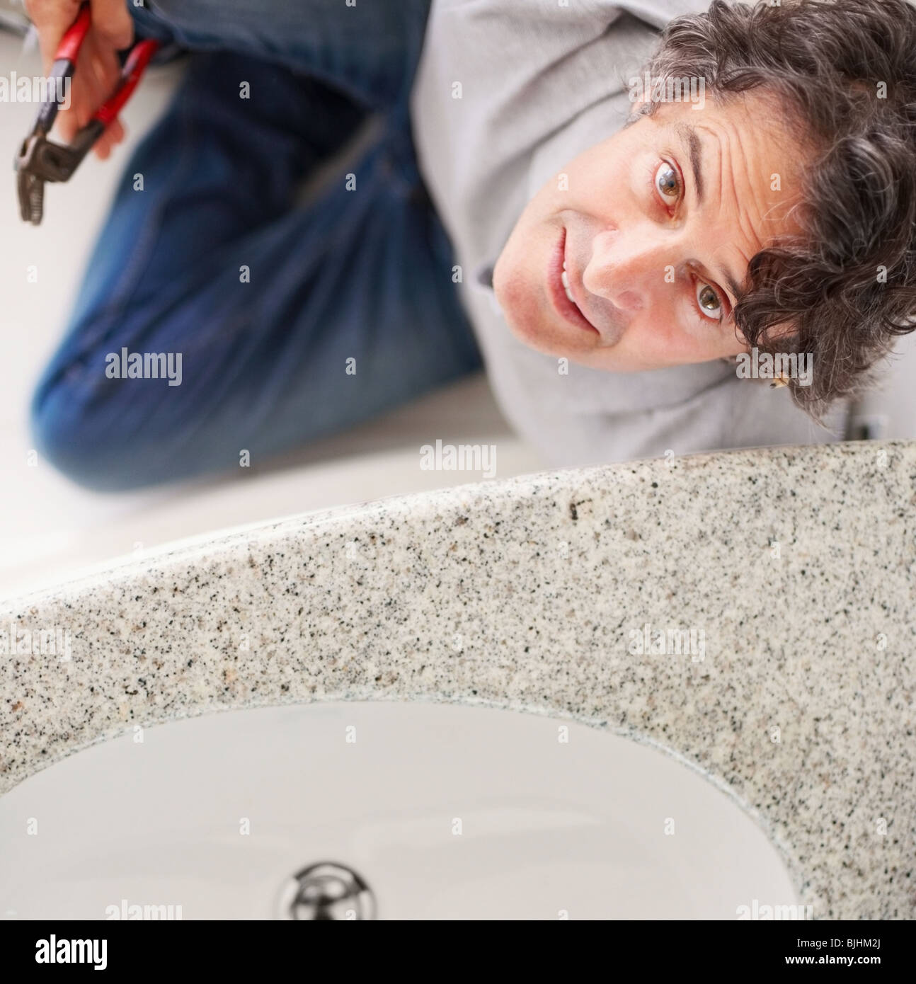 Plumber fixing leaky sink hi-res stock photography and images - Alamy