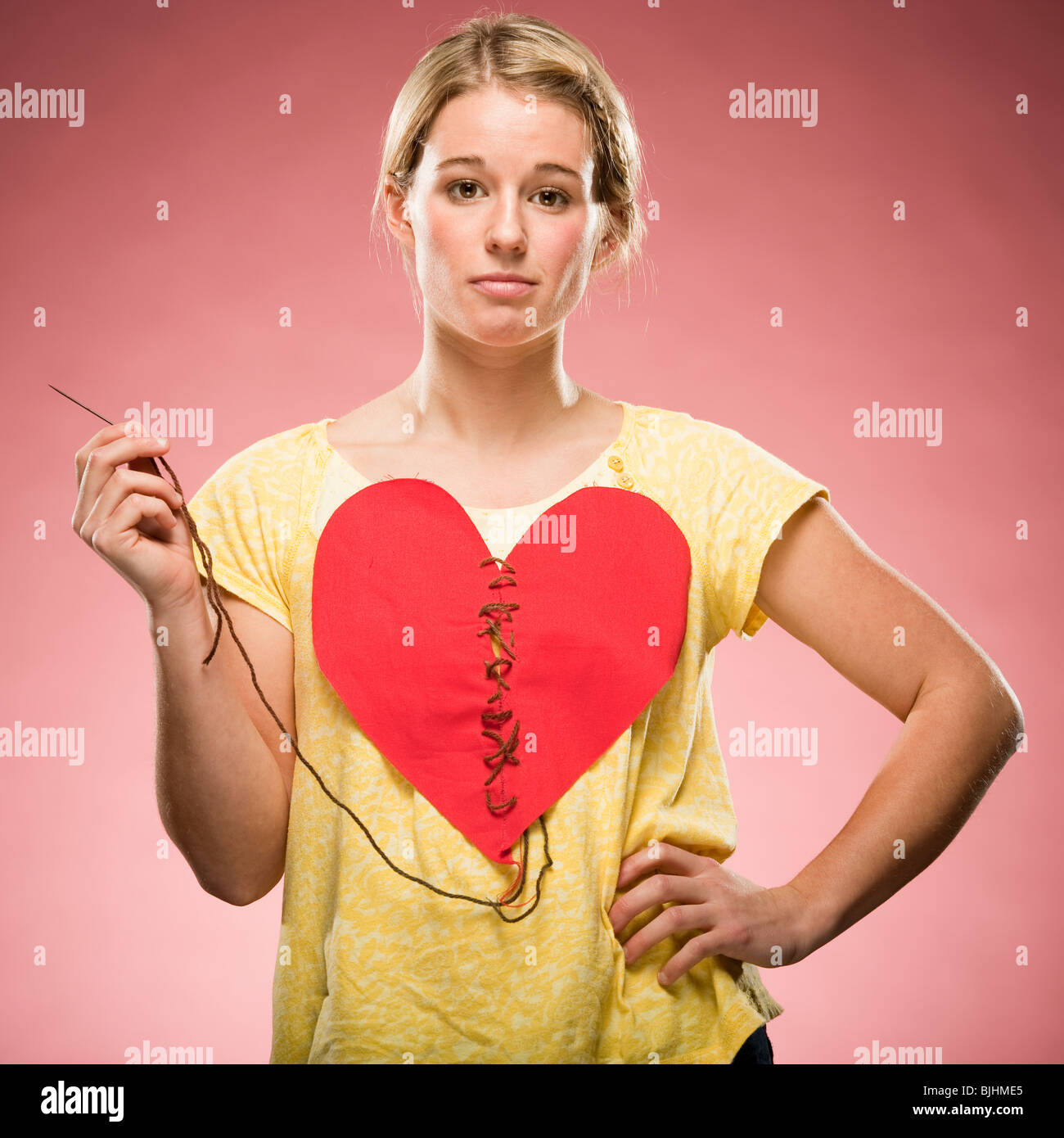 woman sewing up her own heart Stock Photo - Alamy