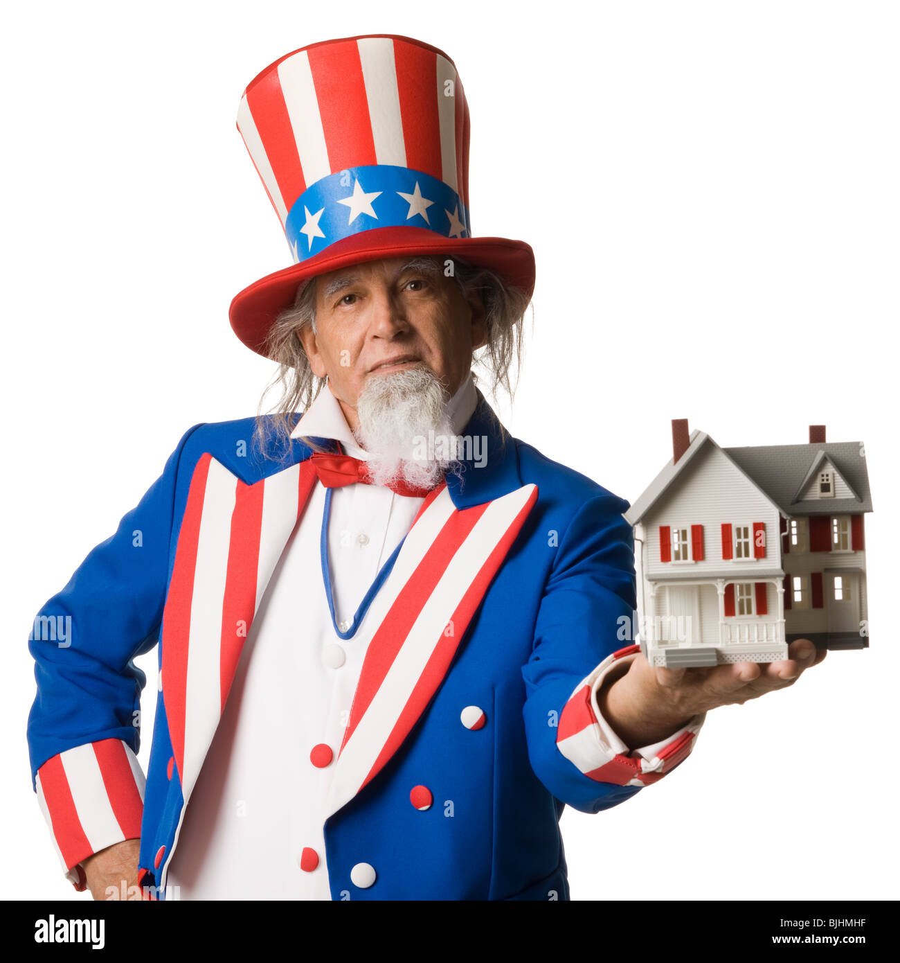 uncle sam holding a house in his hand Stock Photo - Alamy