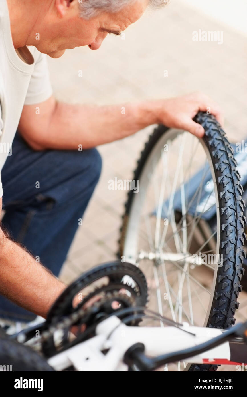 Man repairing bicycle Stock Photo - Alamy