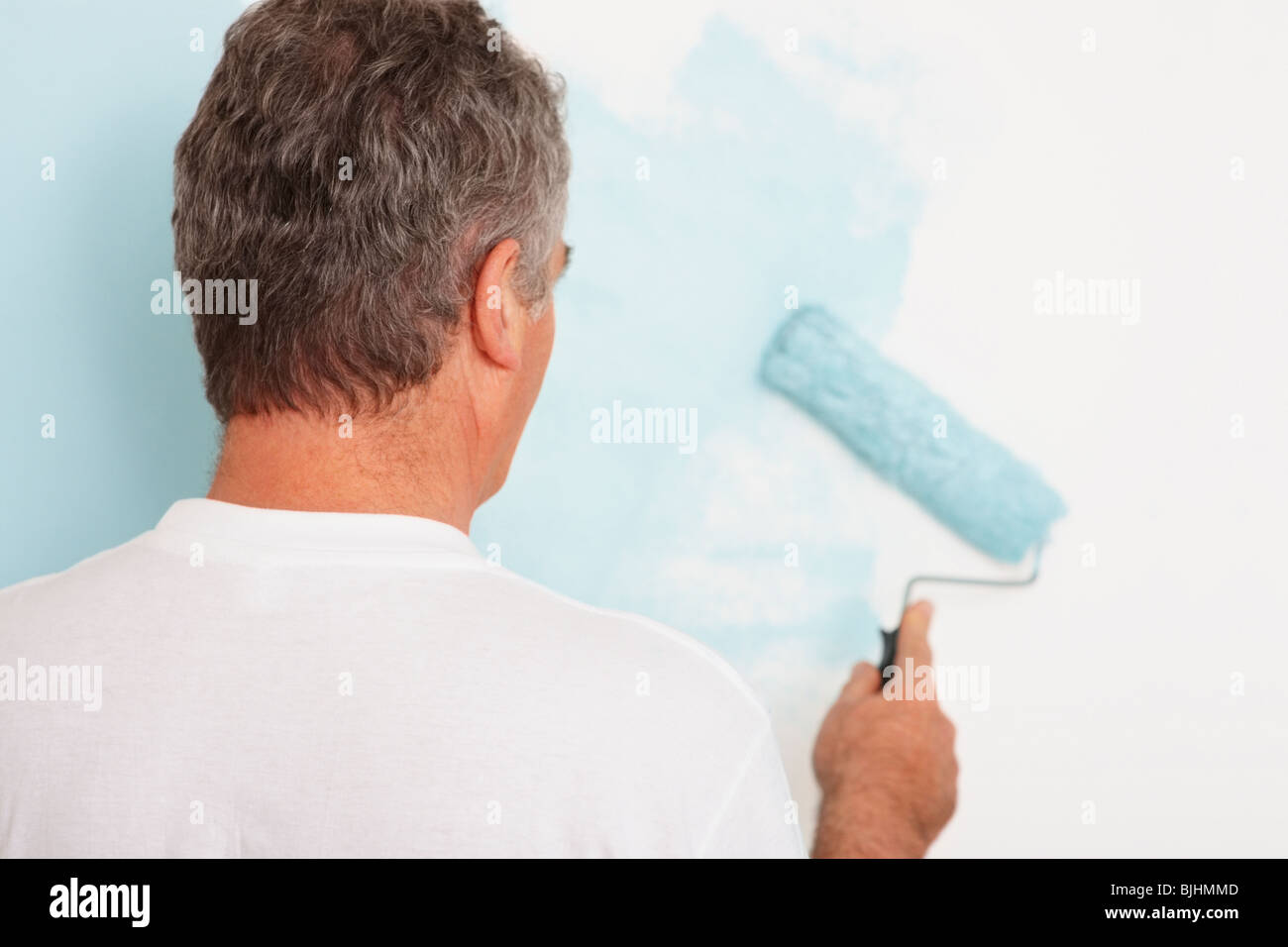 Man painting wall Stock Photo - Alamy