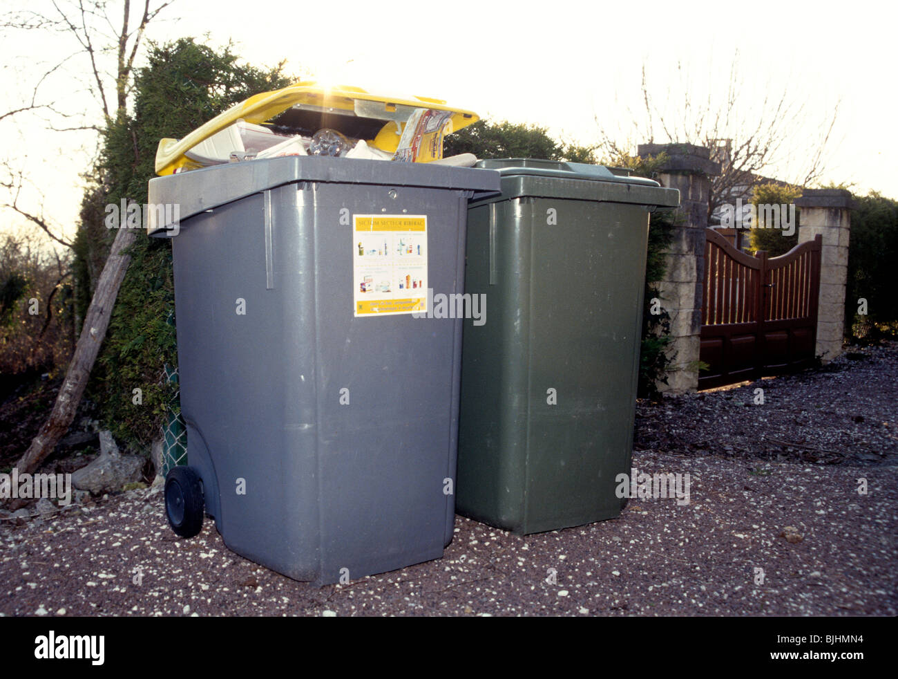 Two recycling wheelie bins by roadside Stock Photo - Alamy