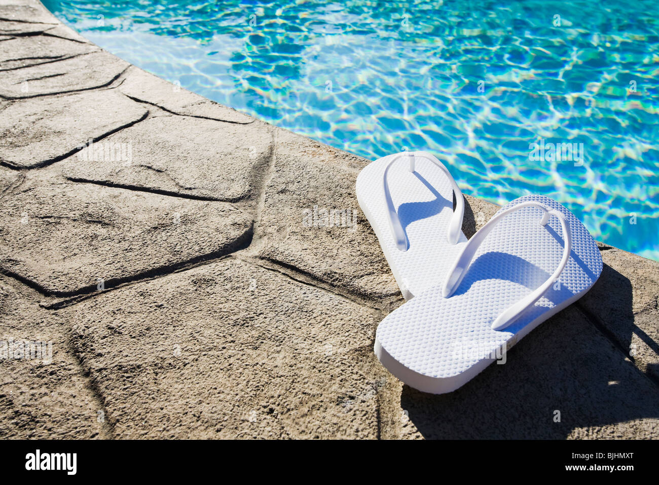 Flip flops by the pool Stock Photo - Alamy