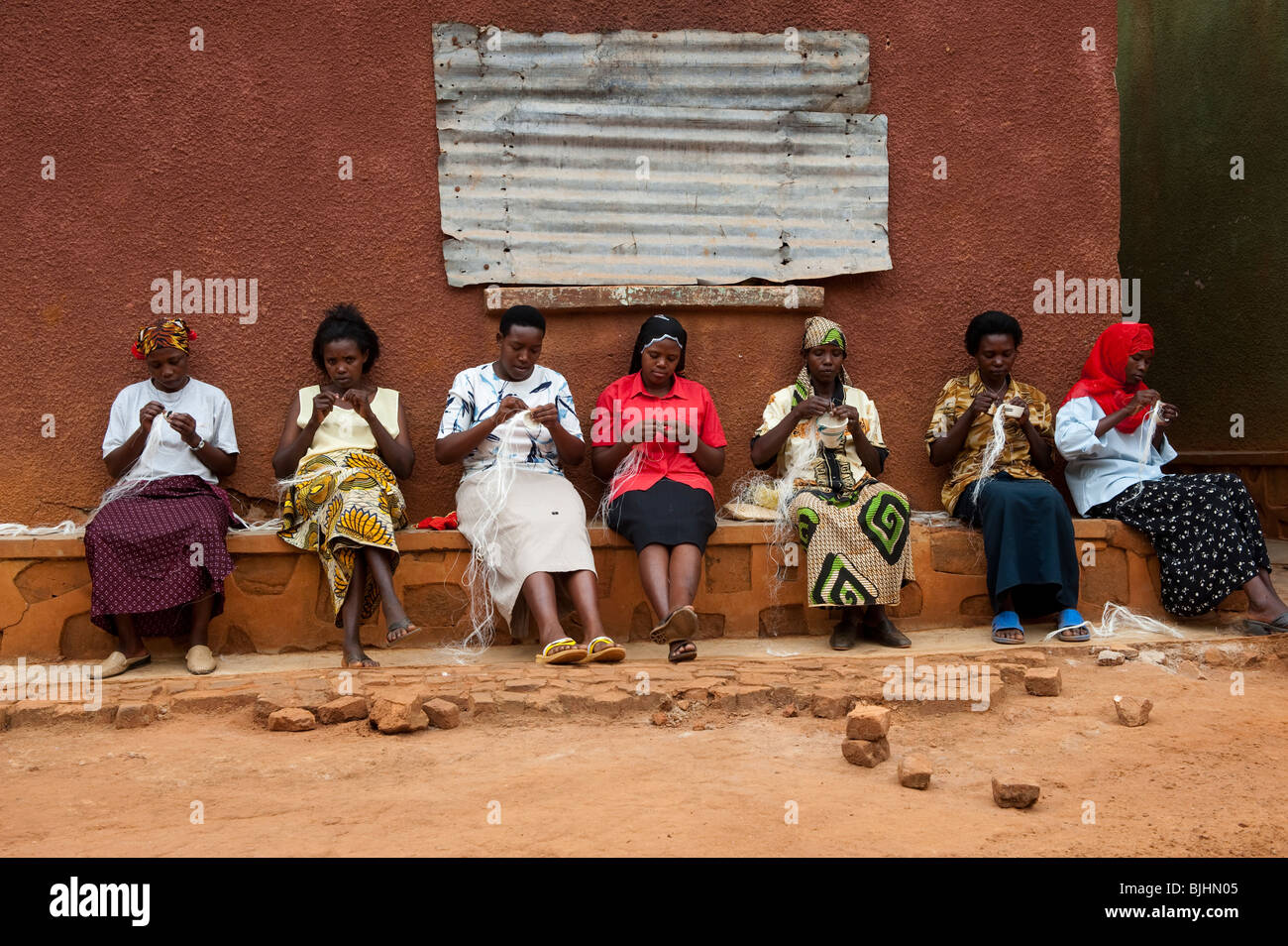 Ladies group working together, weaving produce to sell at local markets ...
