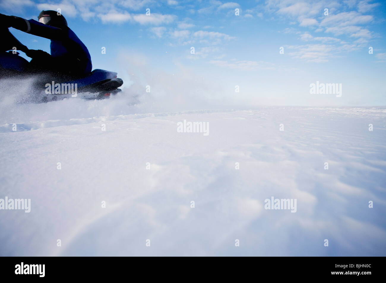 Snowmobile in motion Stock Photo - Alamy
