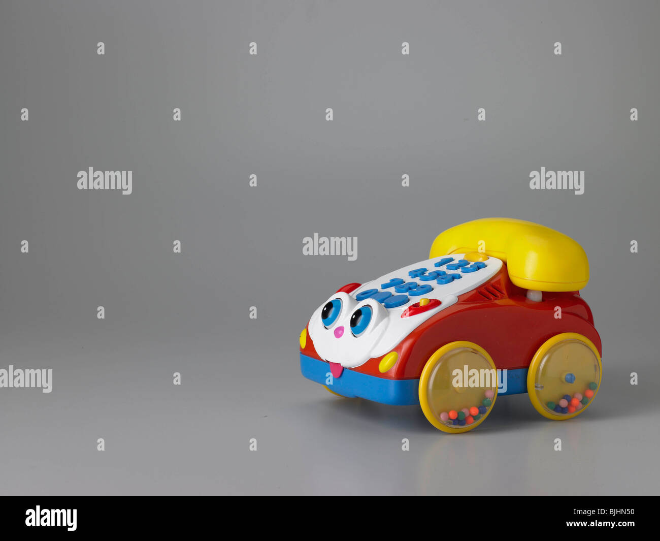 Fun toy telephone on grey Stock Photo - Alamy