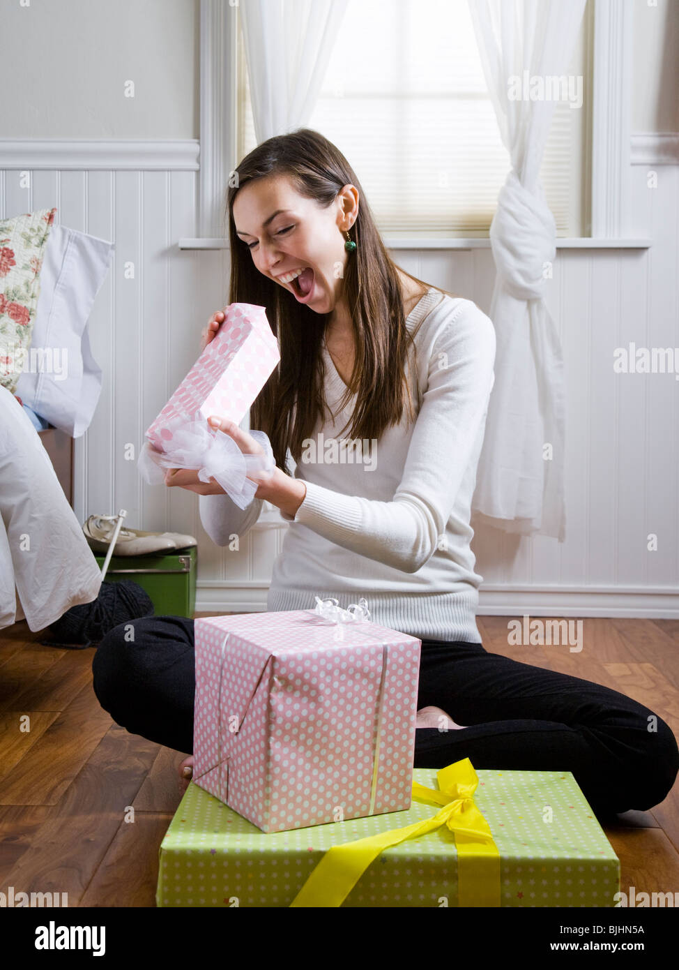 Surprised young woman opening gifts hi-res stock photography and images ...
