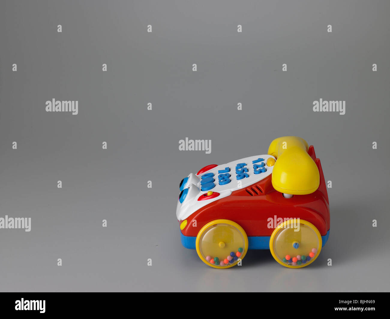 Fun toy telephone on grey Stock Photo - Alamy