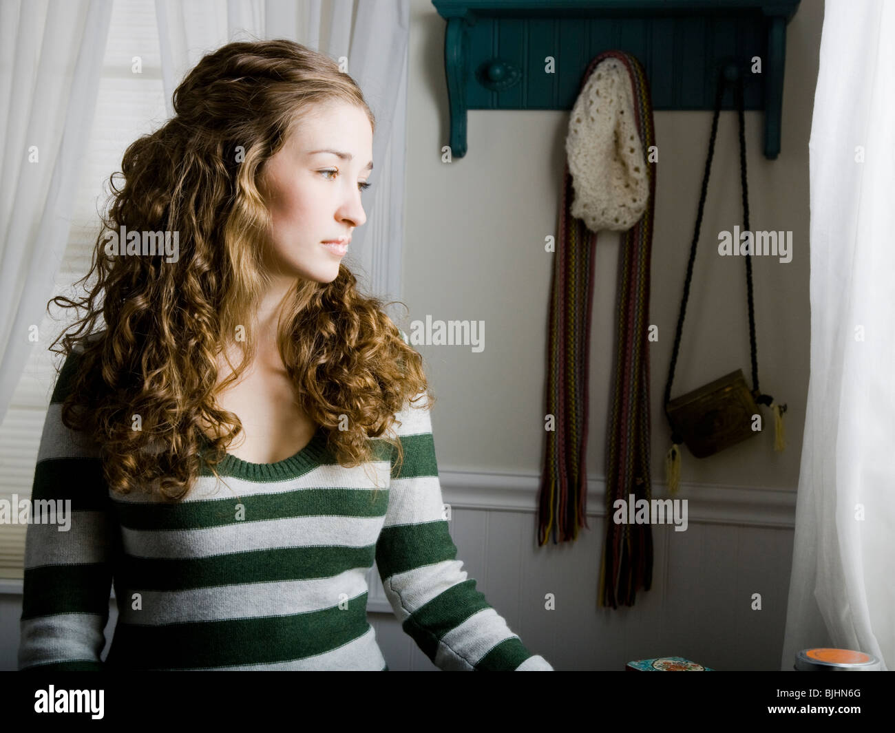 Young woman sitting next to window hi-res stock photography and images ...