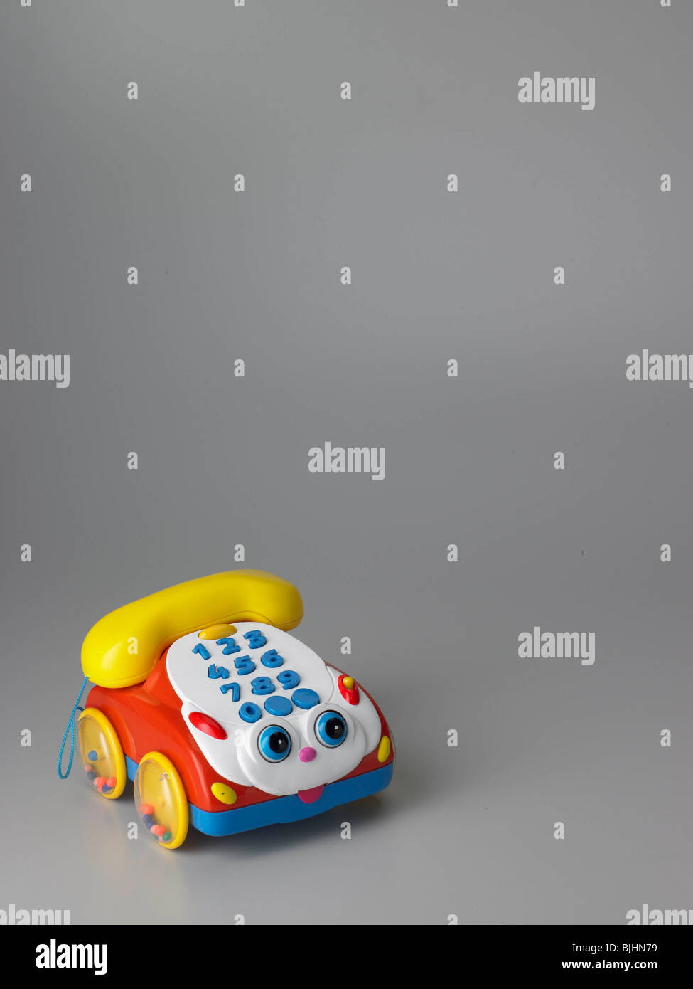 Fun toy telephone on grey Stock Photo - Alamy