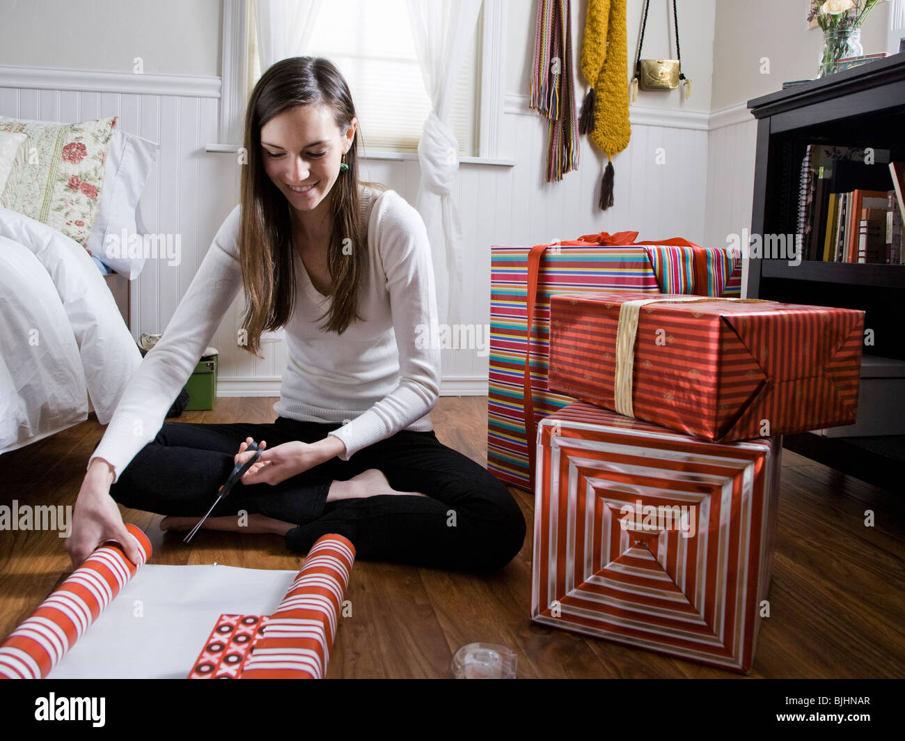 woman sitting on the floor wrapping presents Stock Photo - Alamy