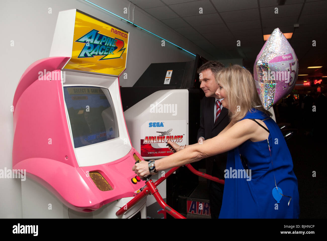 A woman playing on the machines in the Amusement Arcade, Southwold Pier ...