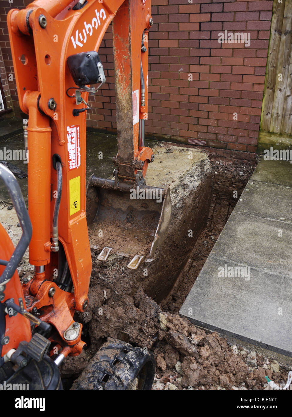 Kubota mini digger digging foundations for extension to semi-detached ...