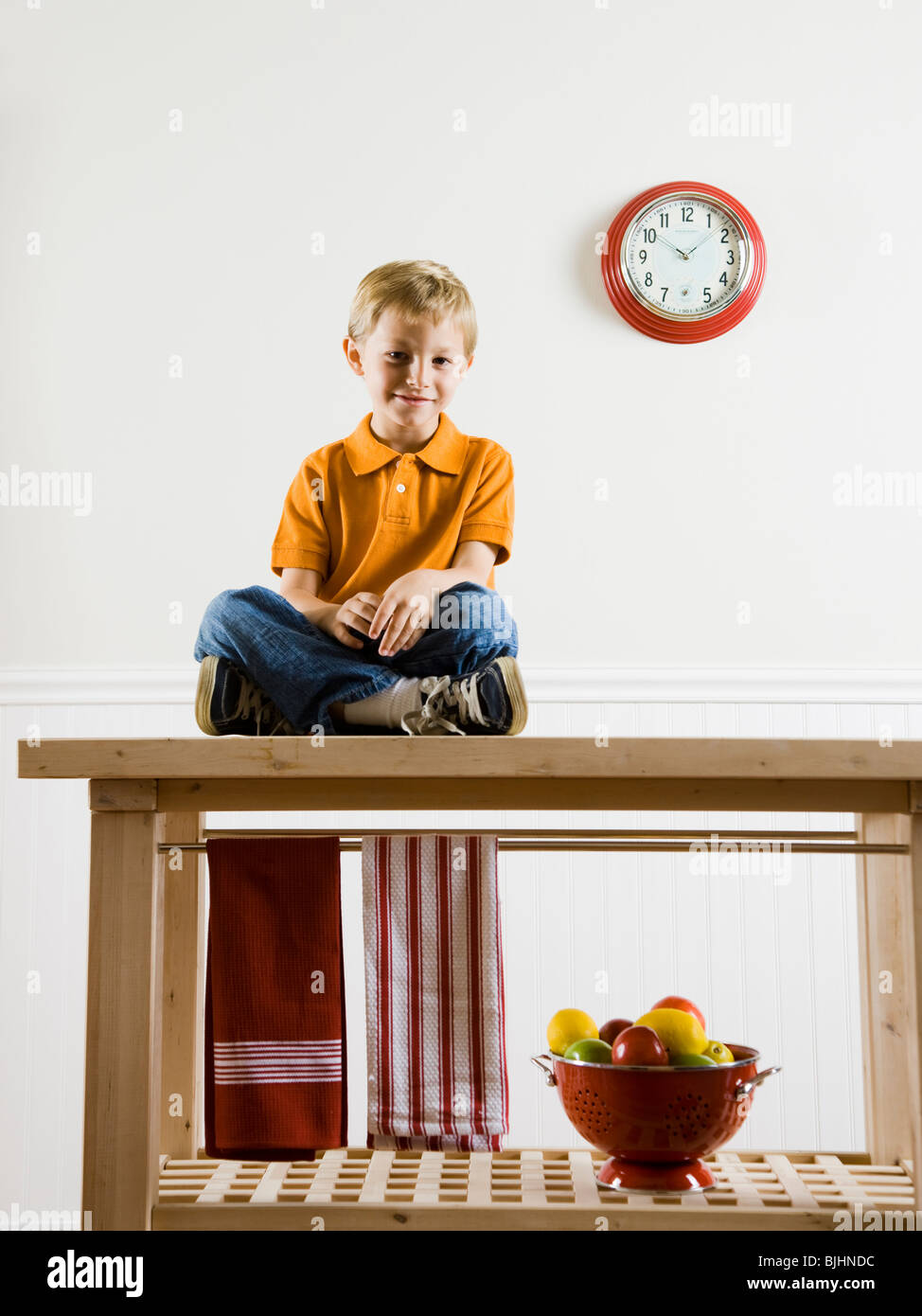 boy sitting on a kitchen table Stock Photo - Alamy