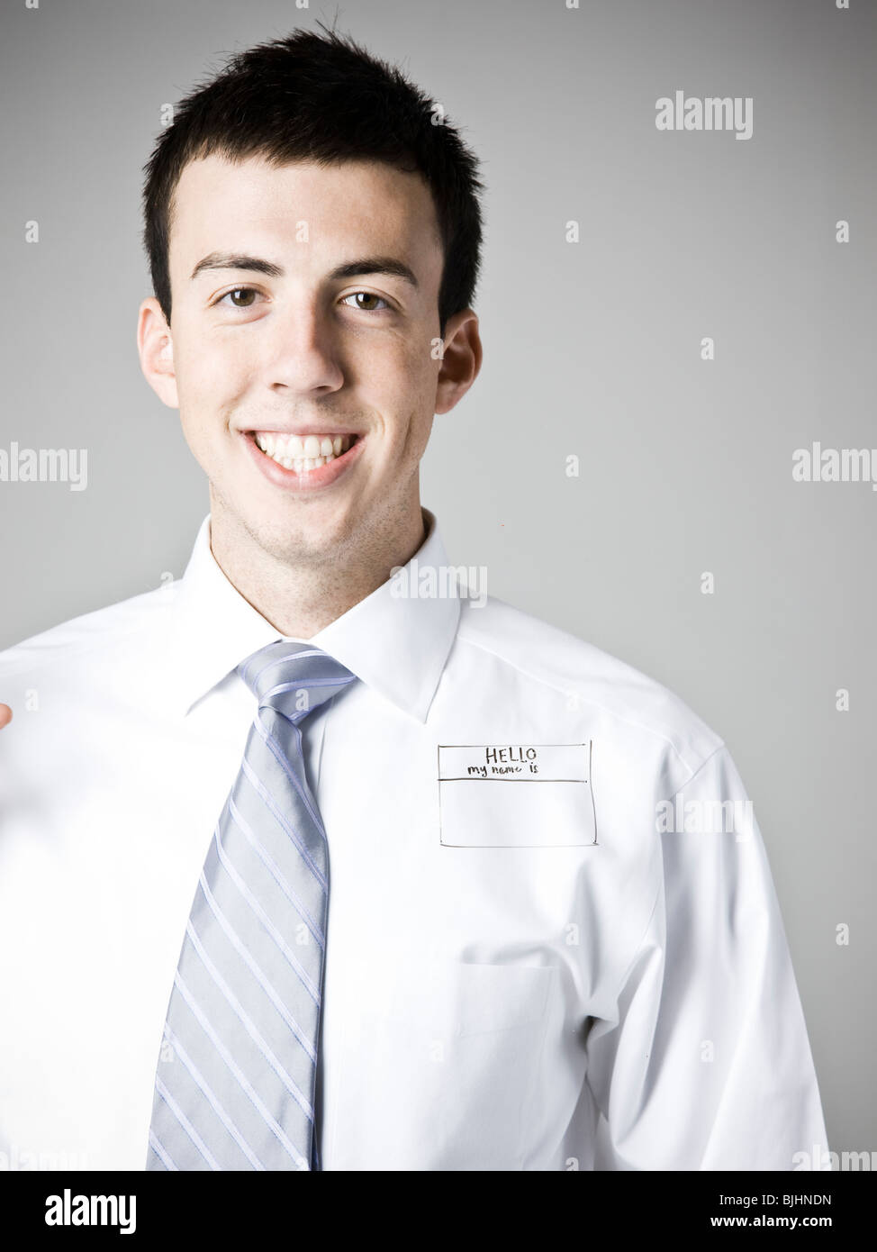 man wearing a tag that says hello, my name is Stock Photo - Alamy
