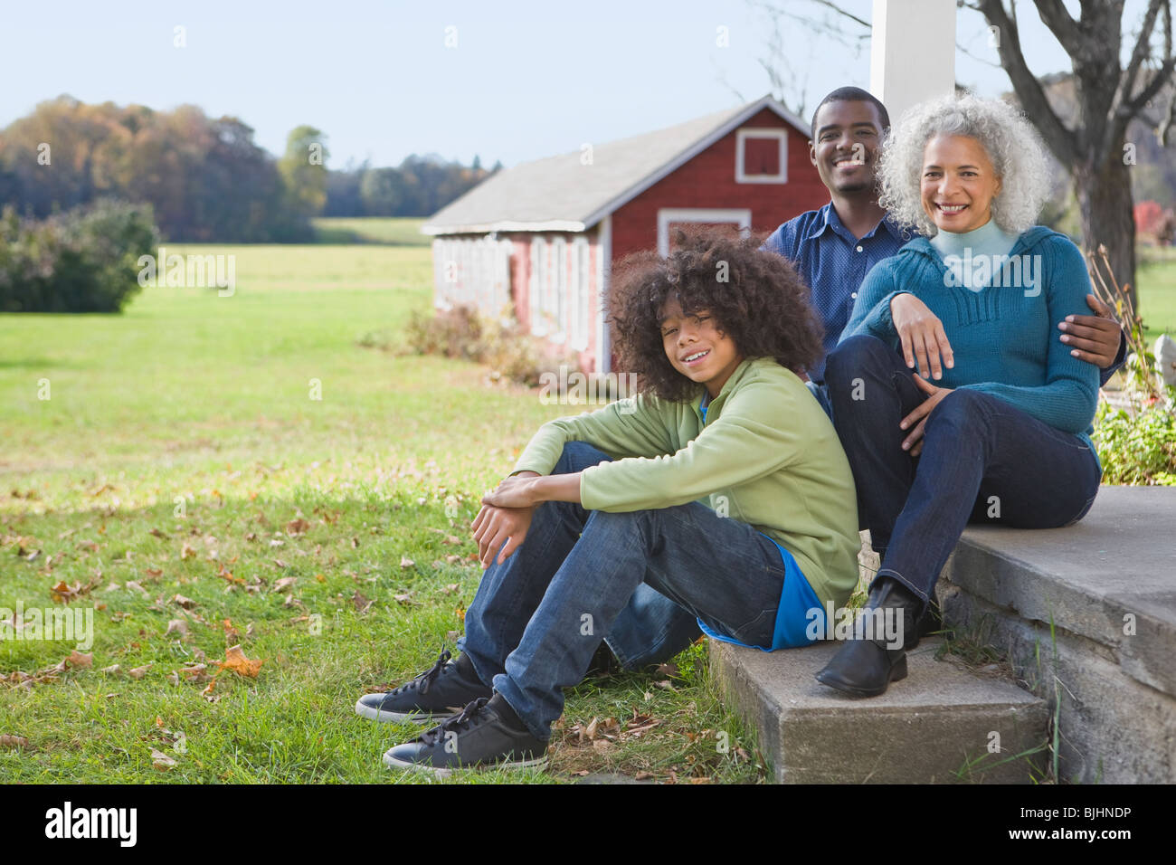 Family relaxing together on porch hi-res stock photography and images ...